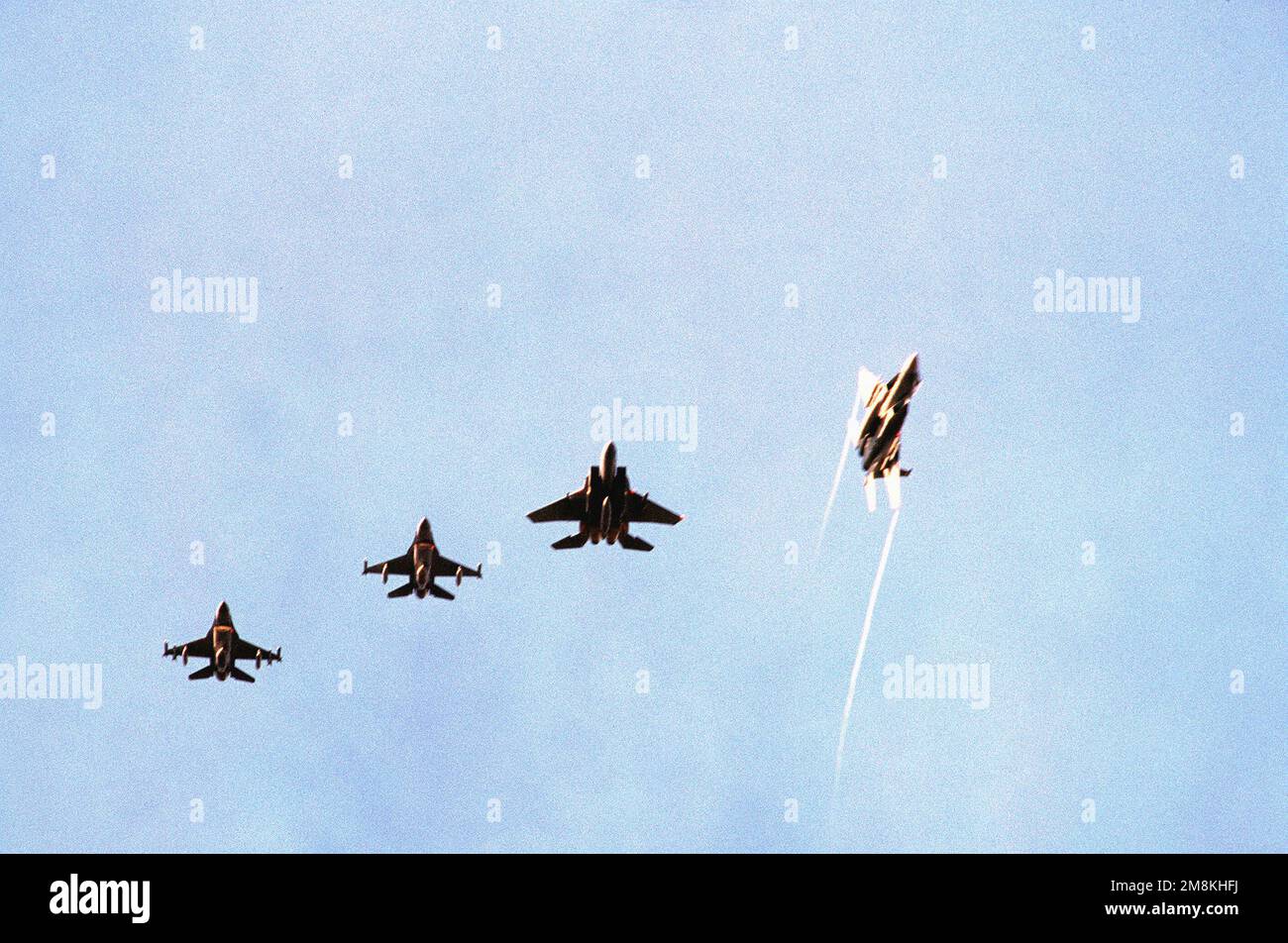 American F-15s and F-16s fly together as they approach the air field ...