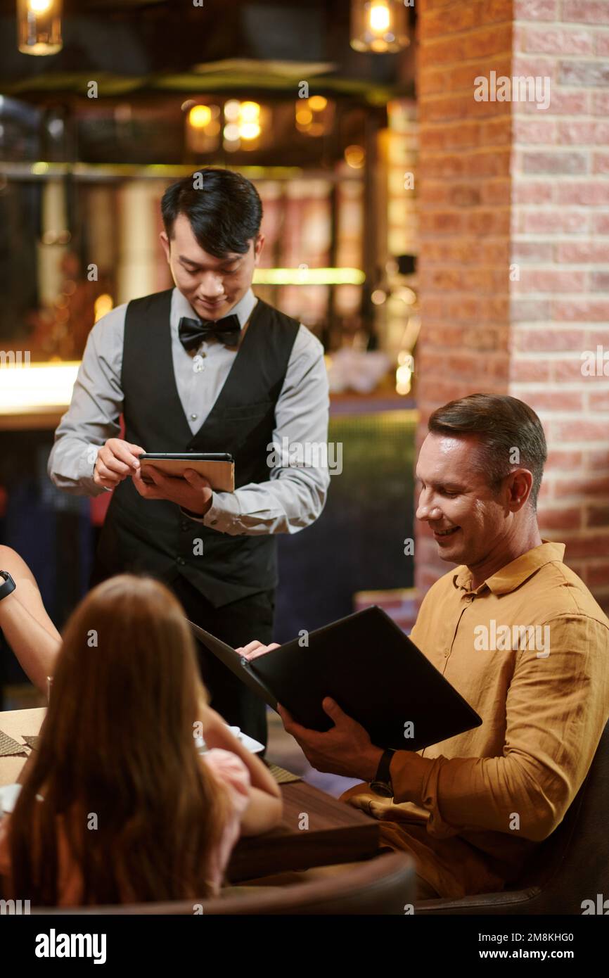 Happy family ordering food in fancy restaurant Stock Photo - Alamy