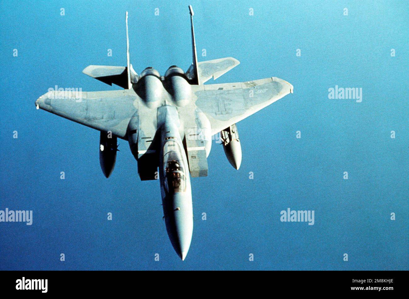 An air to air overhead view of a US Air Force F-15 Eagle as it makes an ...