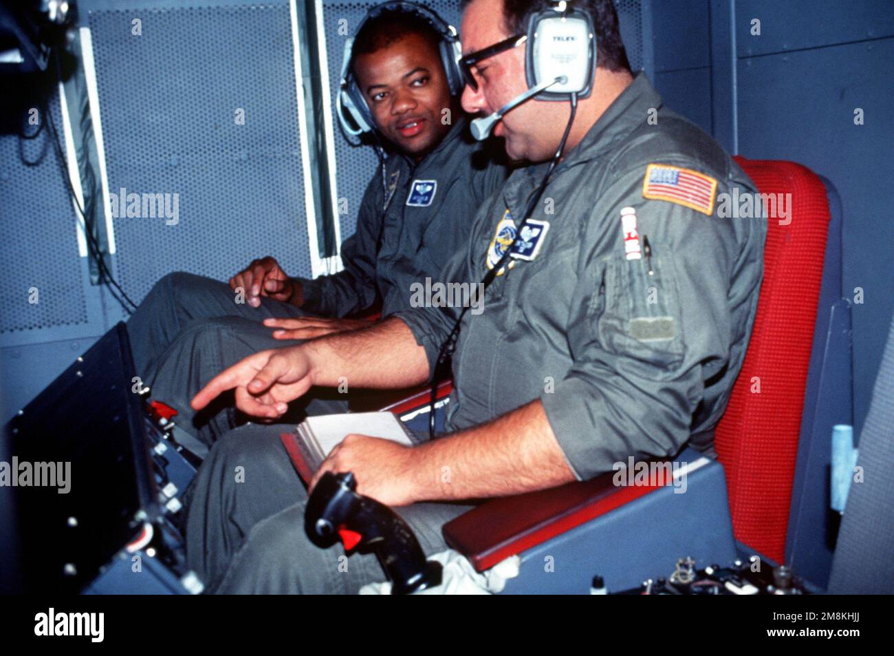 TECH. SGT. Jay Davis Jr. (left), a refueling boom instructor, works ...