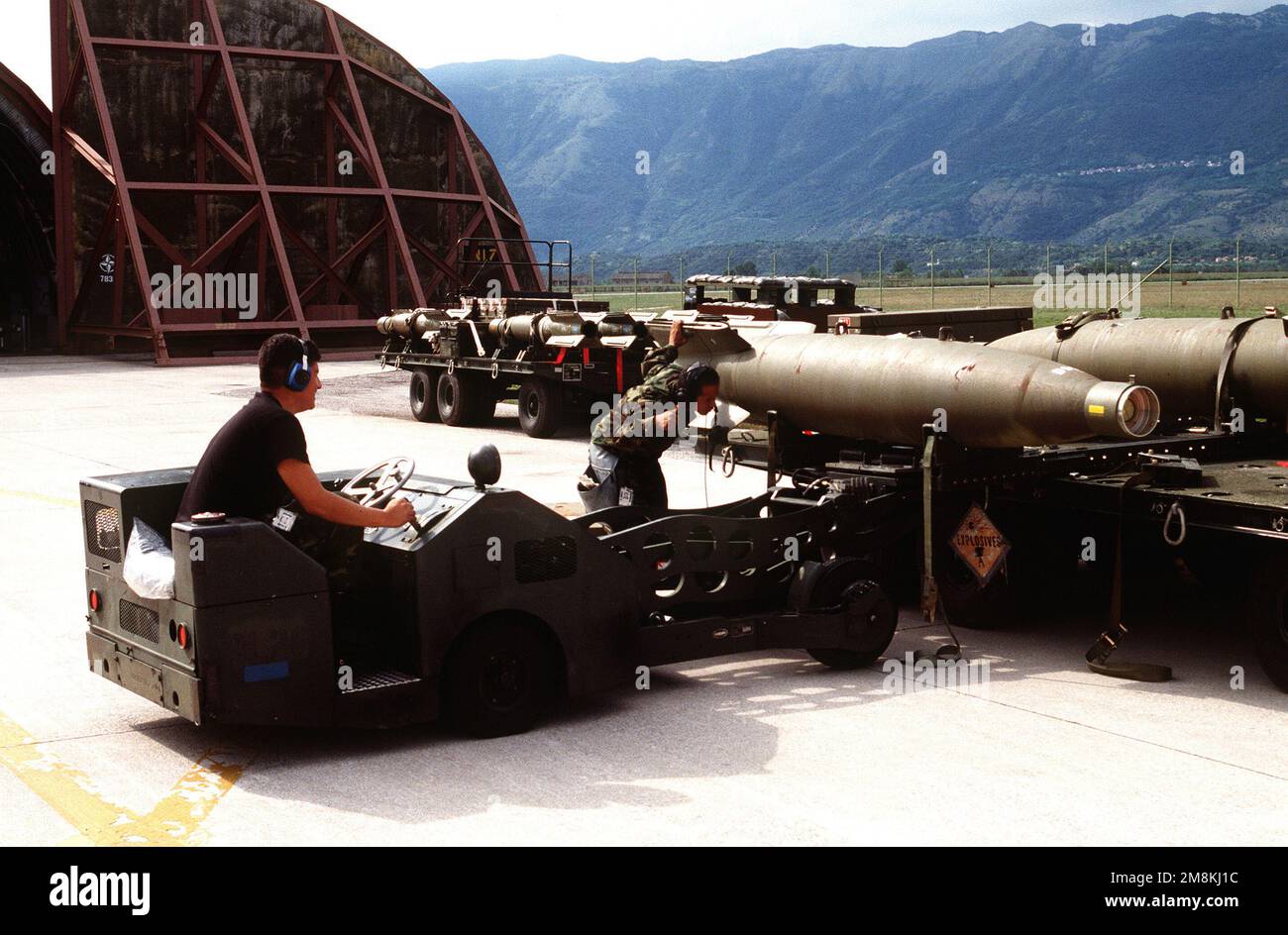 Weapon loaders unload GBU-10 munitions from an M989A1 heavy expanded ...