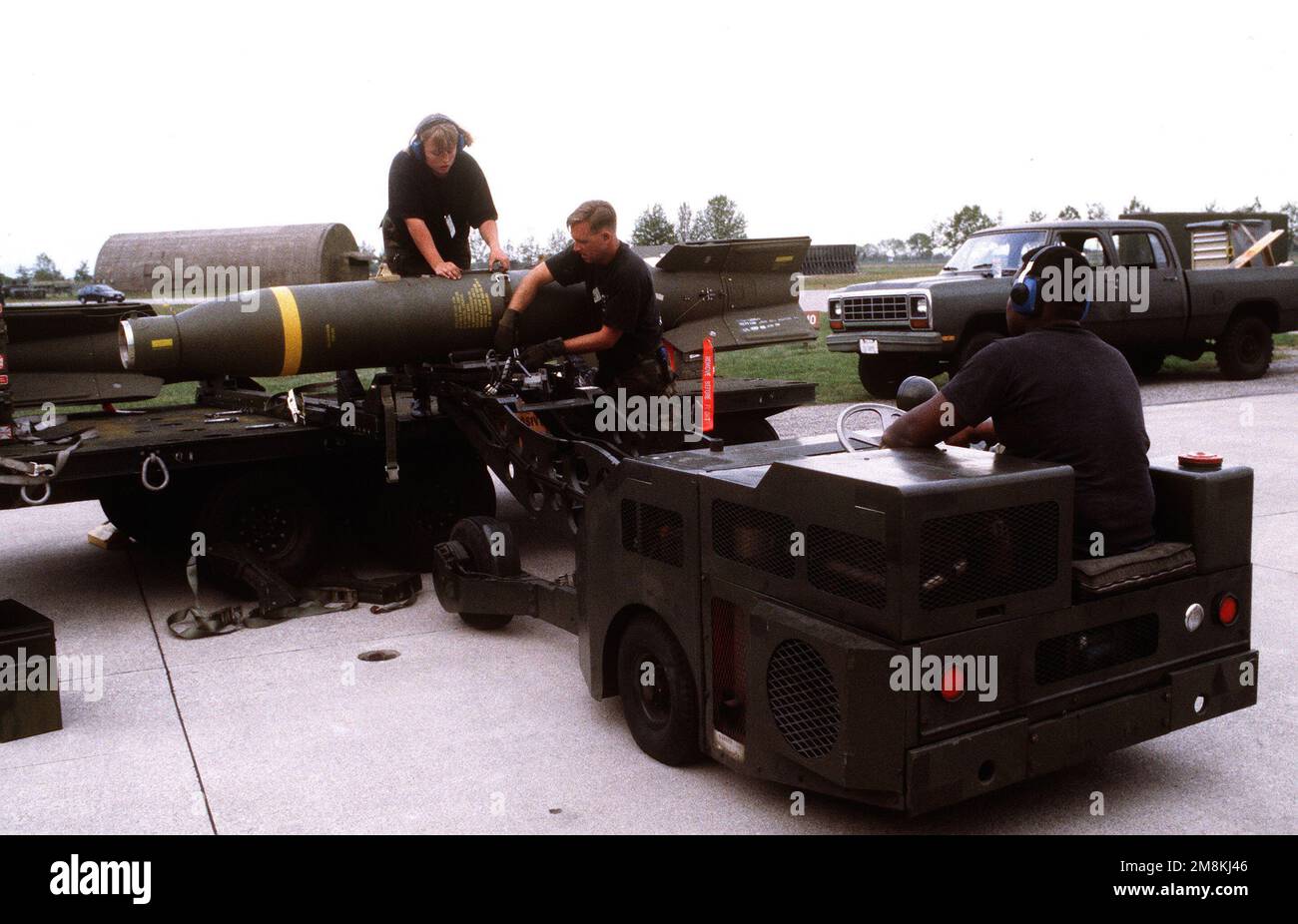 Weapon loaders prepare the main body warhead and tail section of a ...