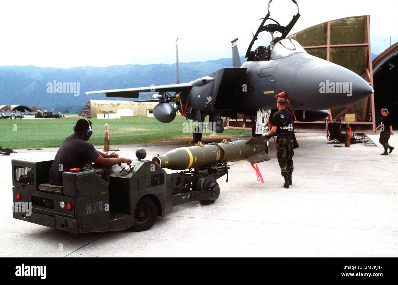 Weapons loaders prepare the main body warhead and tail section of a ...