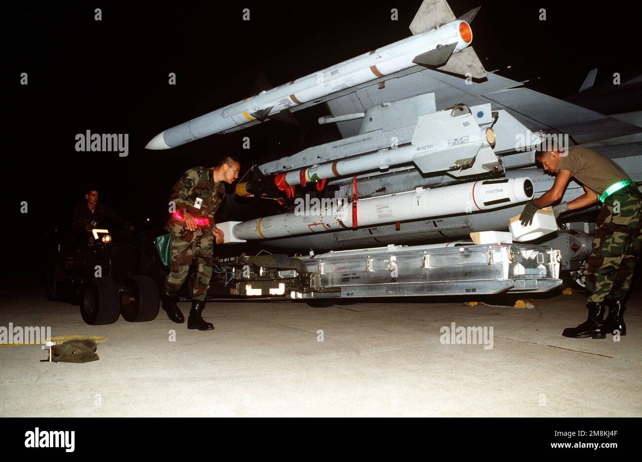 Weapon loaders rearm a US Air Force F-16C Fighting Falcon from the 23rd ...