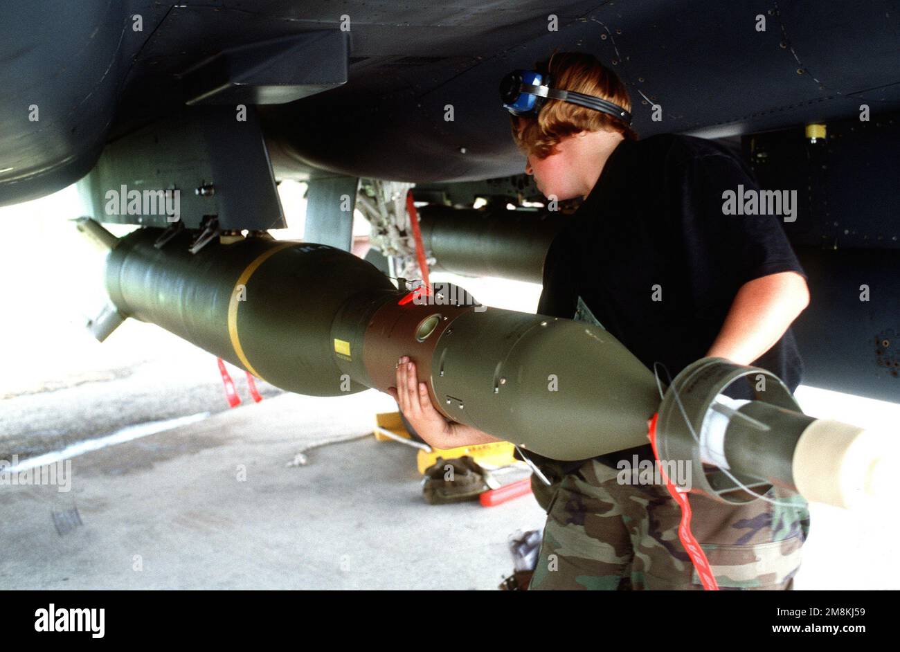 Weapons loaders from the 555th Fighter Squadron load a laser guided ...