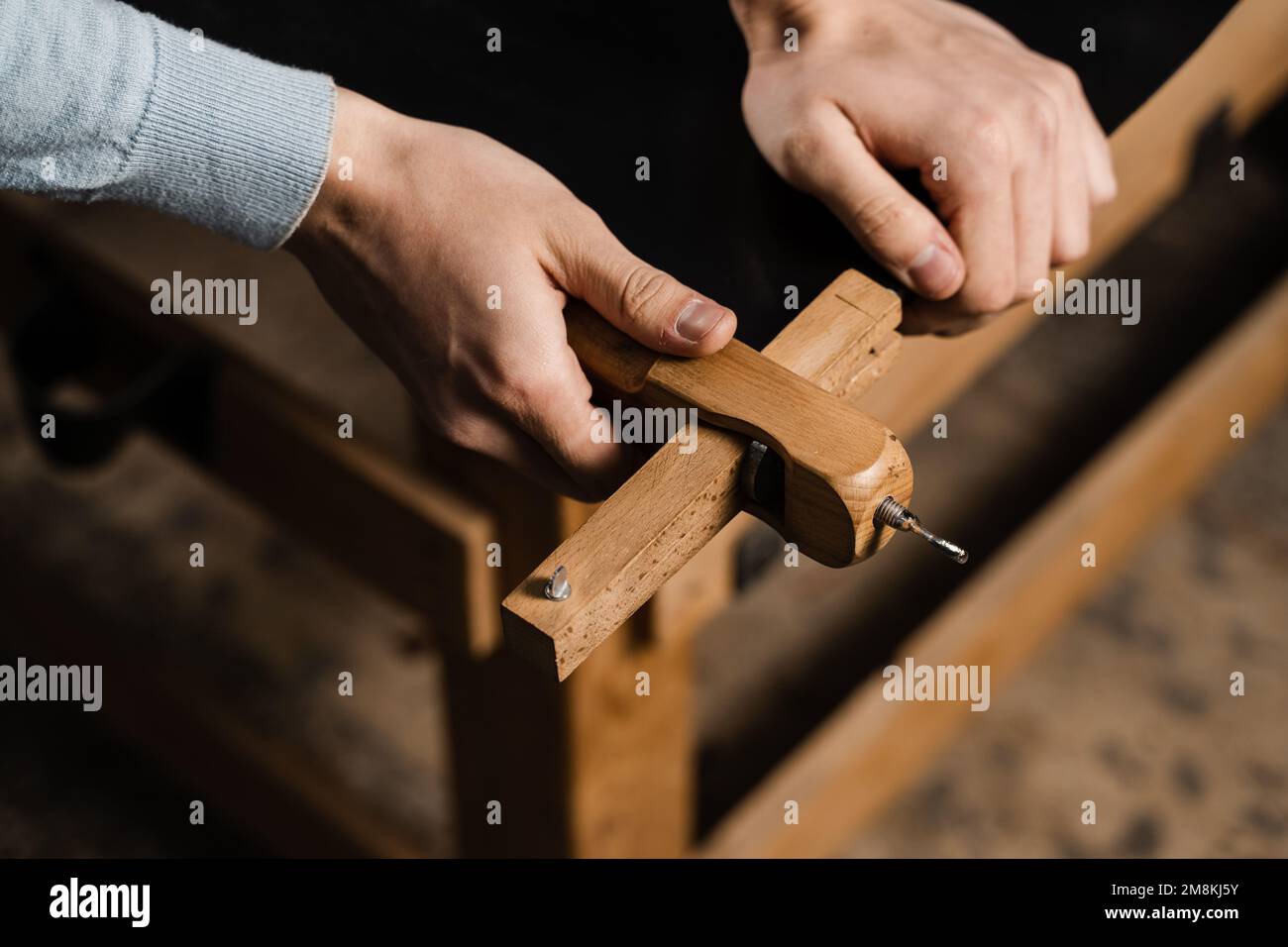 Craftsman is cutting the belt genuine leather using cutter in the ...