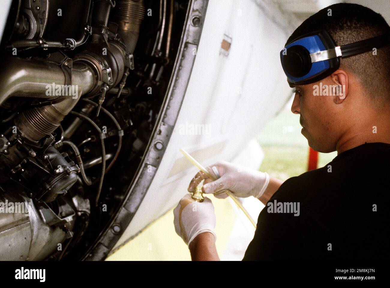 SENIOR AIRMAN Colon takes a fluid sample from an EF-111A Raven aircraft ...