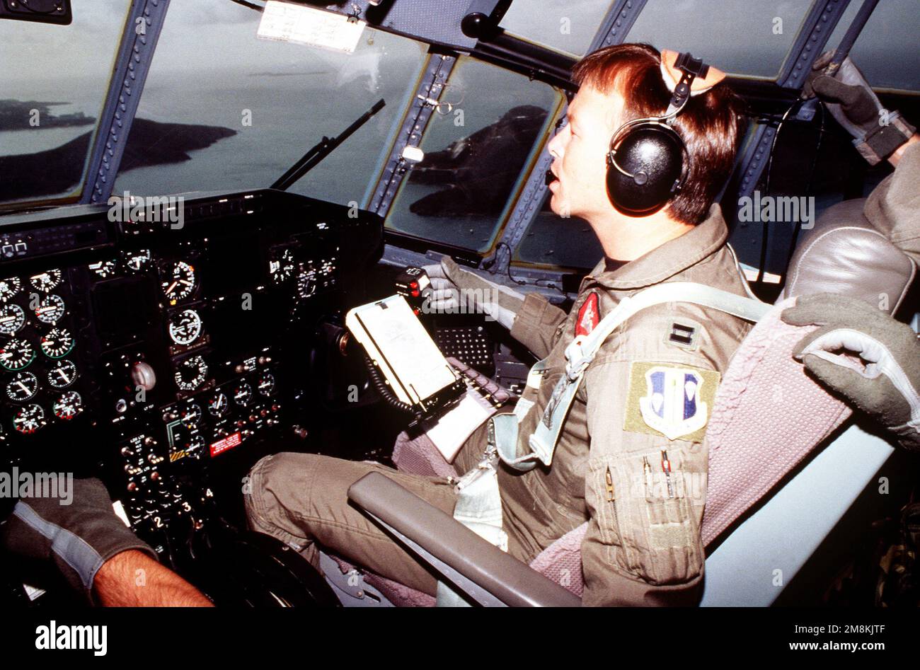 CAPT. Howard Steven, U.S. Air Force, looks over the instrument panel of ...