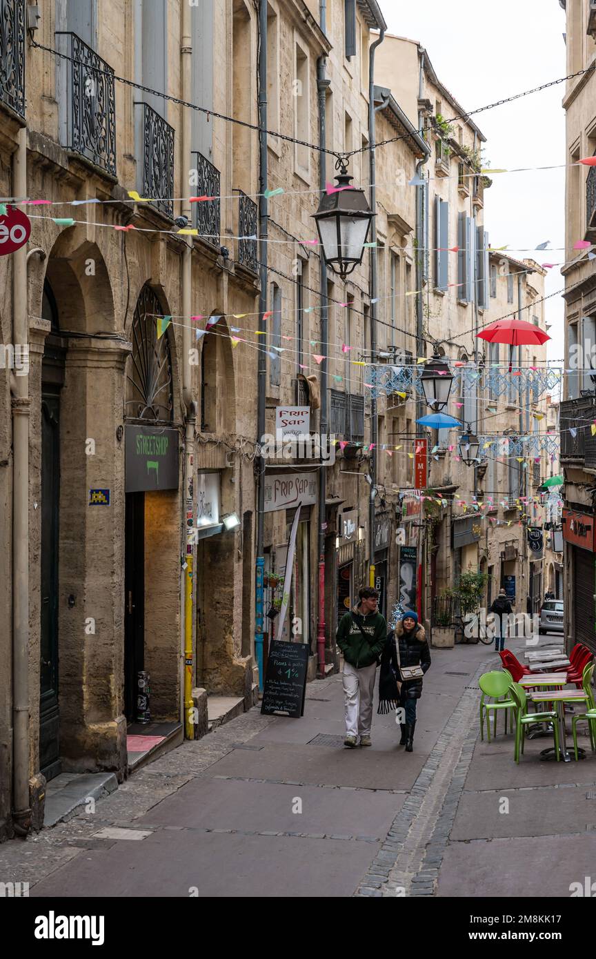 Montpellier, France, >Young couple walking in the comemrcial streets of ...