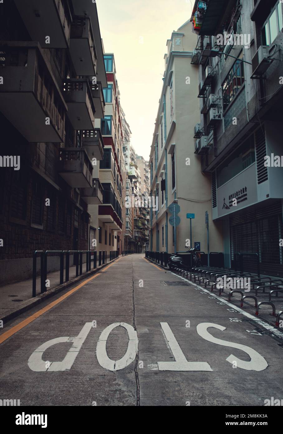 A view of a road with a written stop sign lined with residential ...
