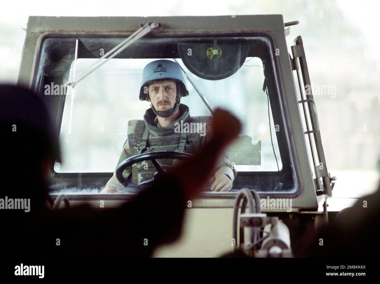 A forward shot of a United Nations ground crew member as he sits in the ...