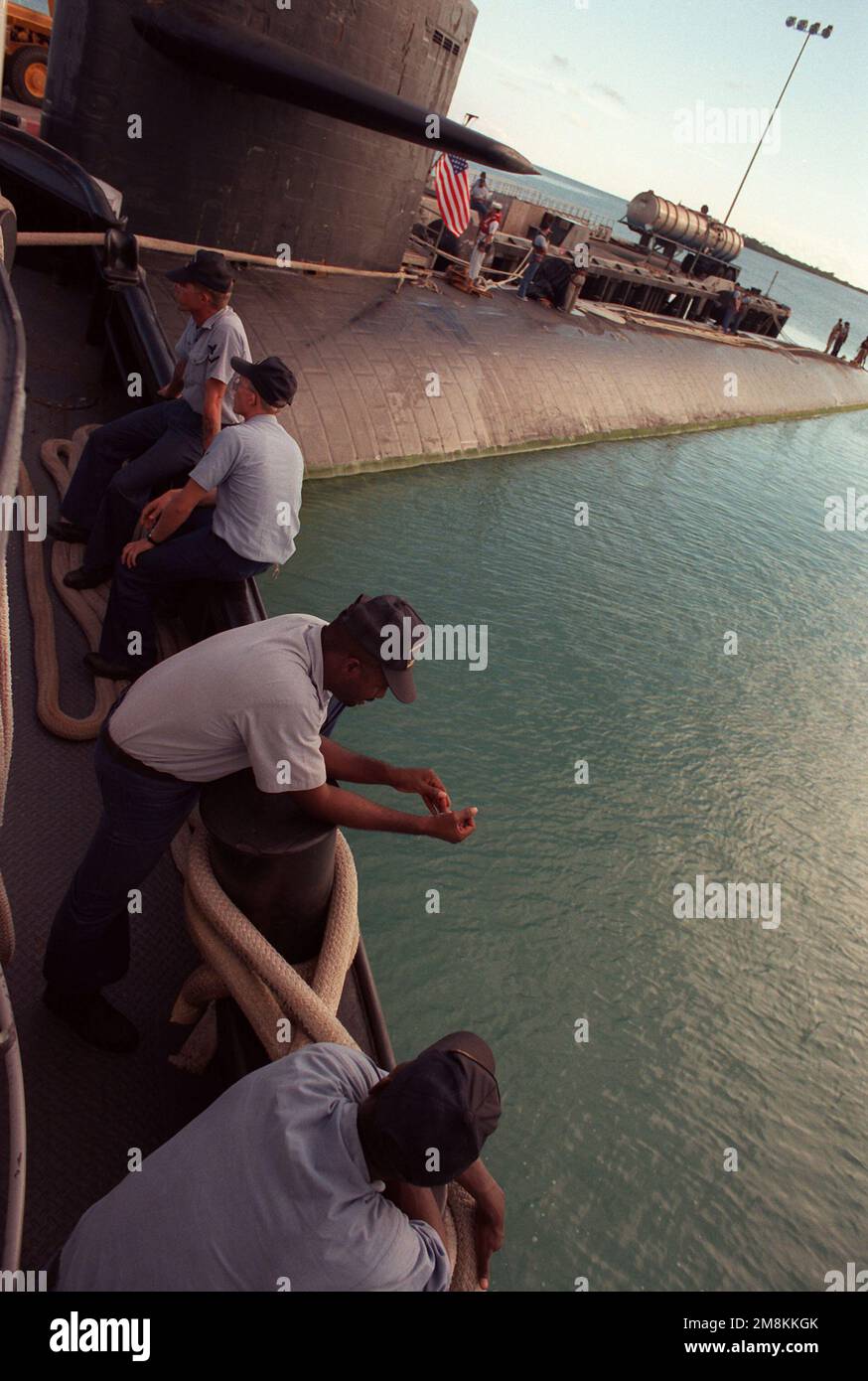 Crewmembers of the yard tugboat Houma (YTB-811) standby in preparation ...