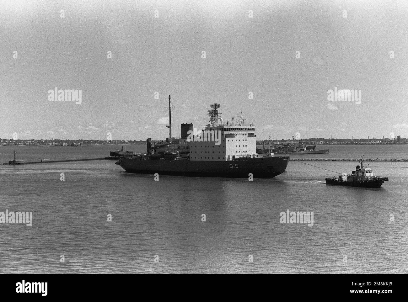 A small service tug boat assists the Argentinian Navy icebreaker ...