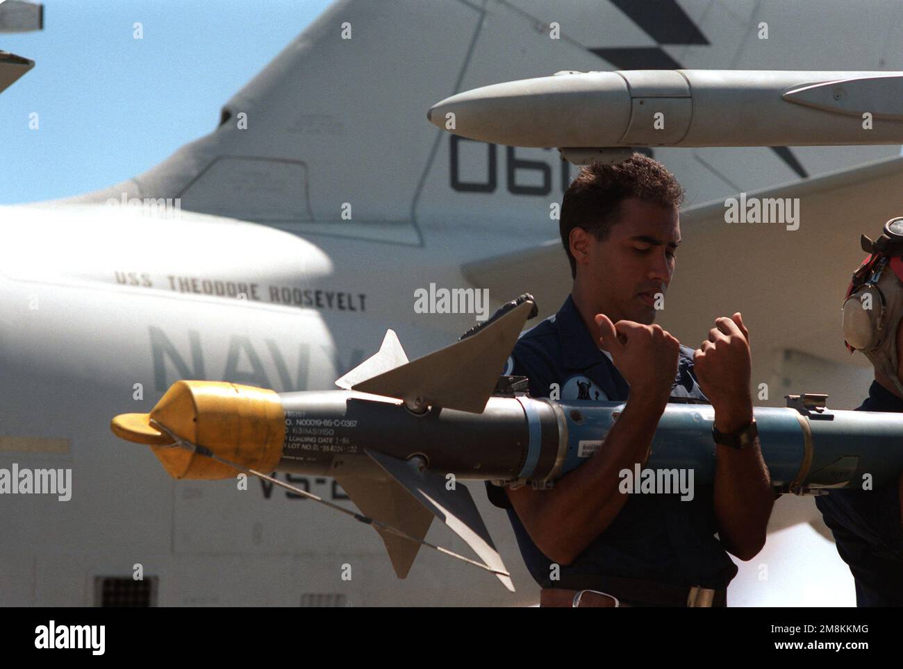 Aviation Ordnanceman AIRMAN (AOAN) Marcos Vasquez wrestles a AIM-9L ...