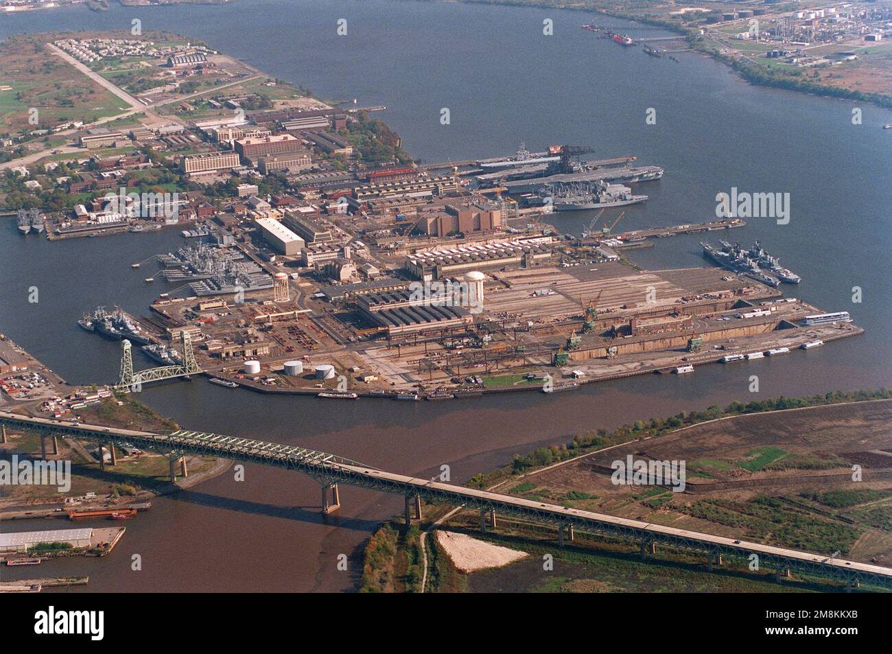 An overall high oblique aerial view of the Philadelphia Naval Shipyard ...