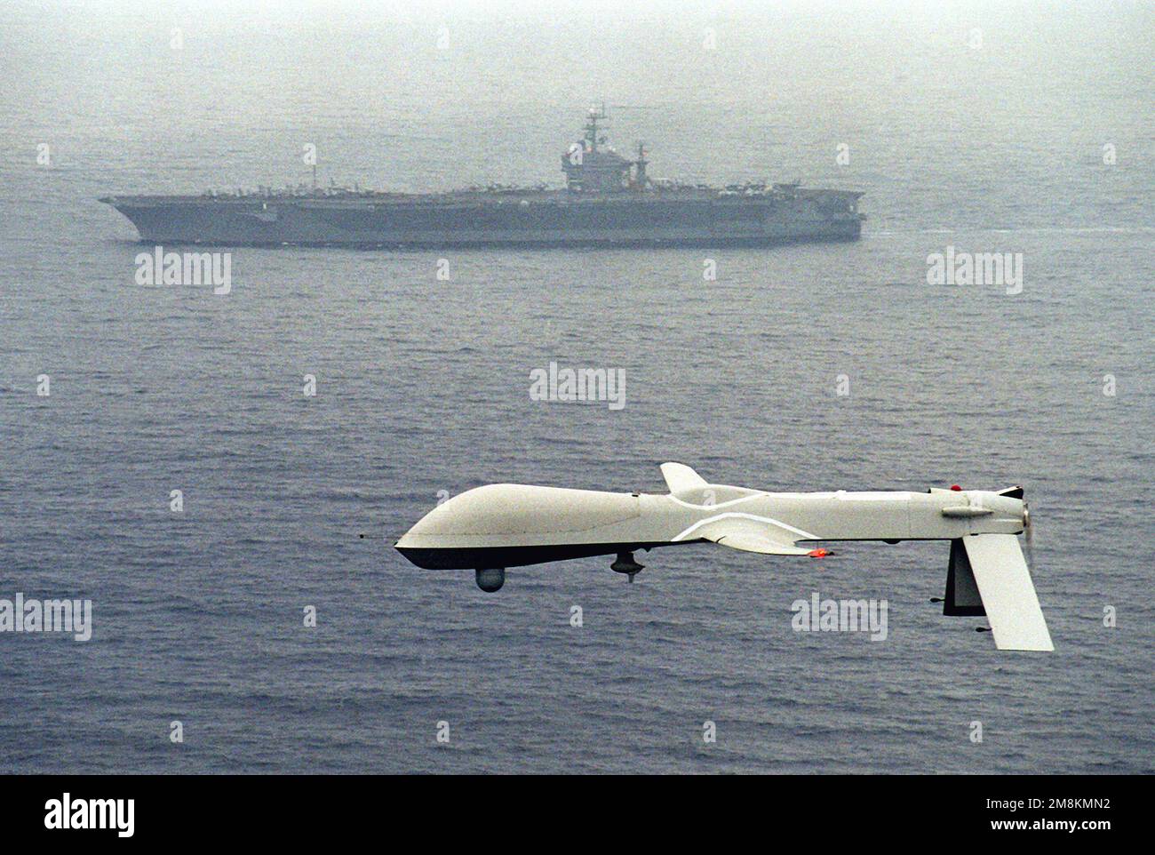 The Predator Unmanned Aerial Vehicle (UAV) flies down the port side of ...