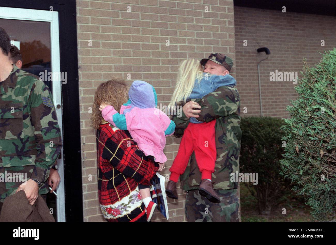SENIOR AIRMAN William Slaybaugh gives his daughter a hug while saying ...