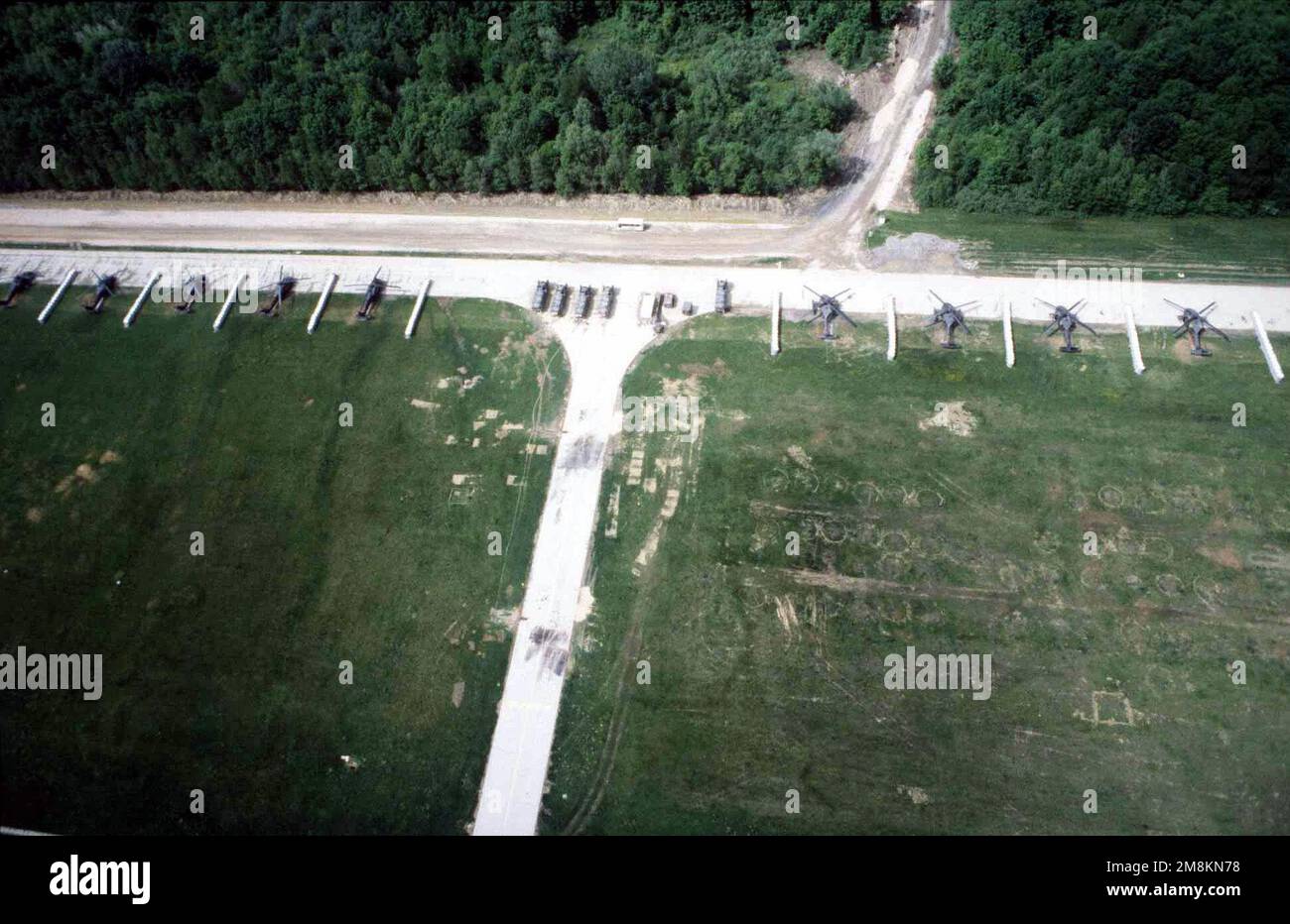 An aerial view of an unidentified airfield. Helicopters are parked ...