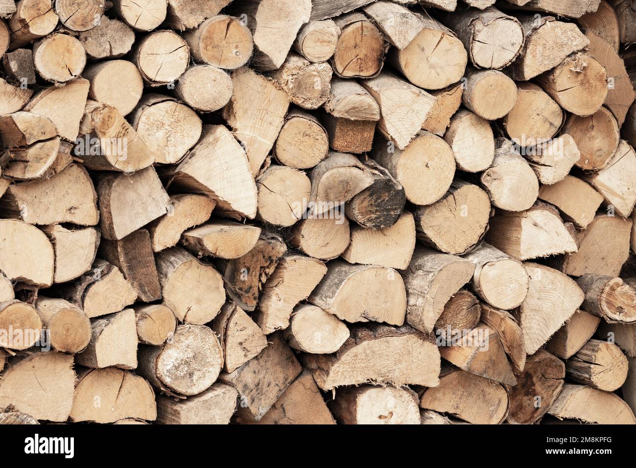 A supply of split and dried hardwood logs stacked up and ready for a ...