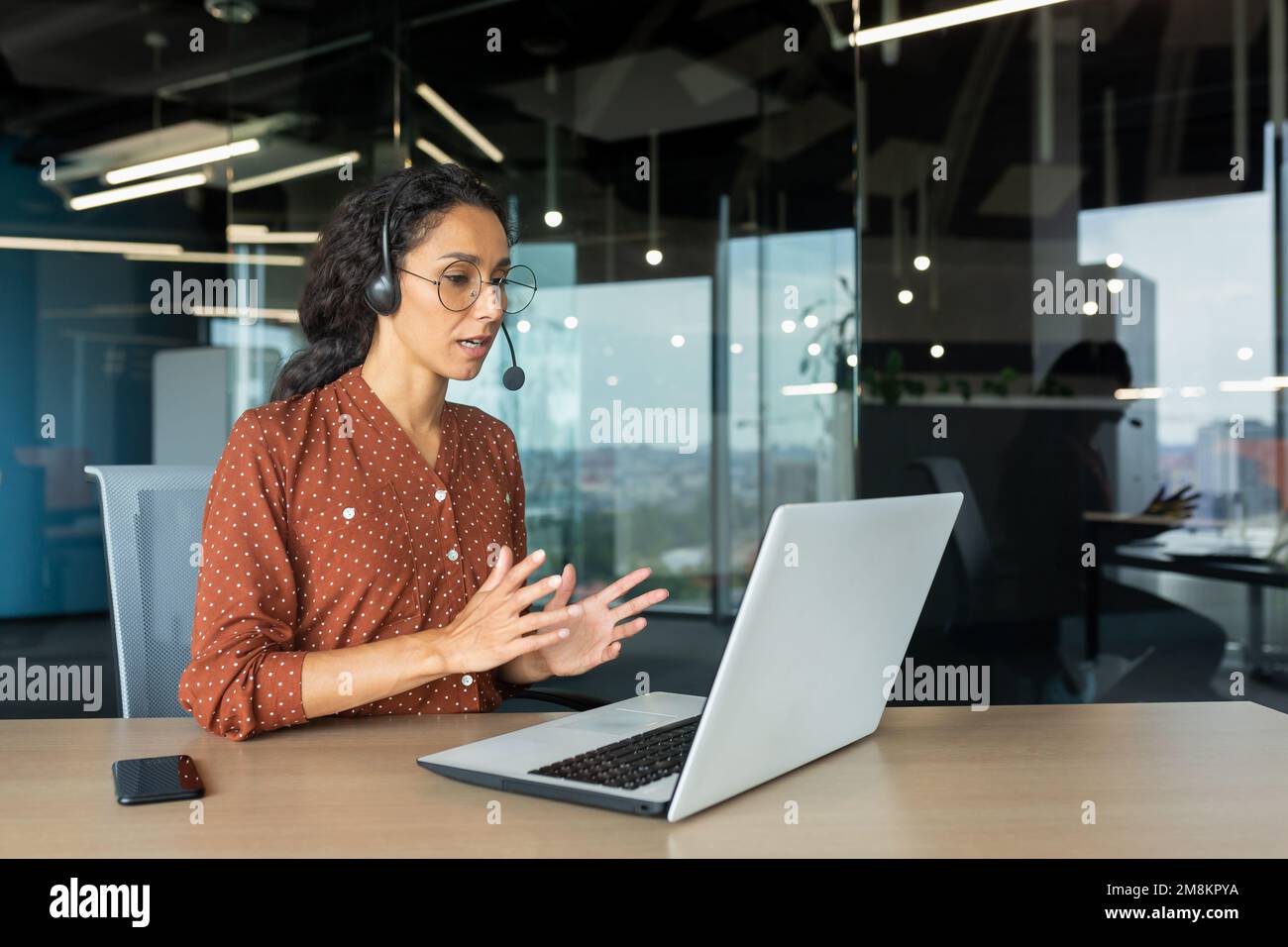 Video call online meeting with colleagues, Hispanic woman working ...