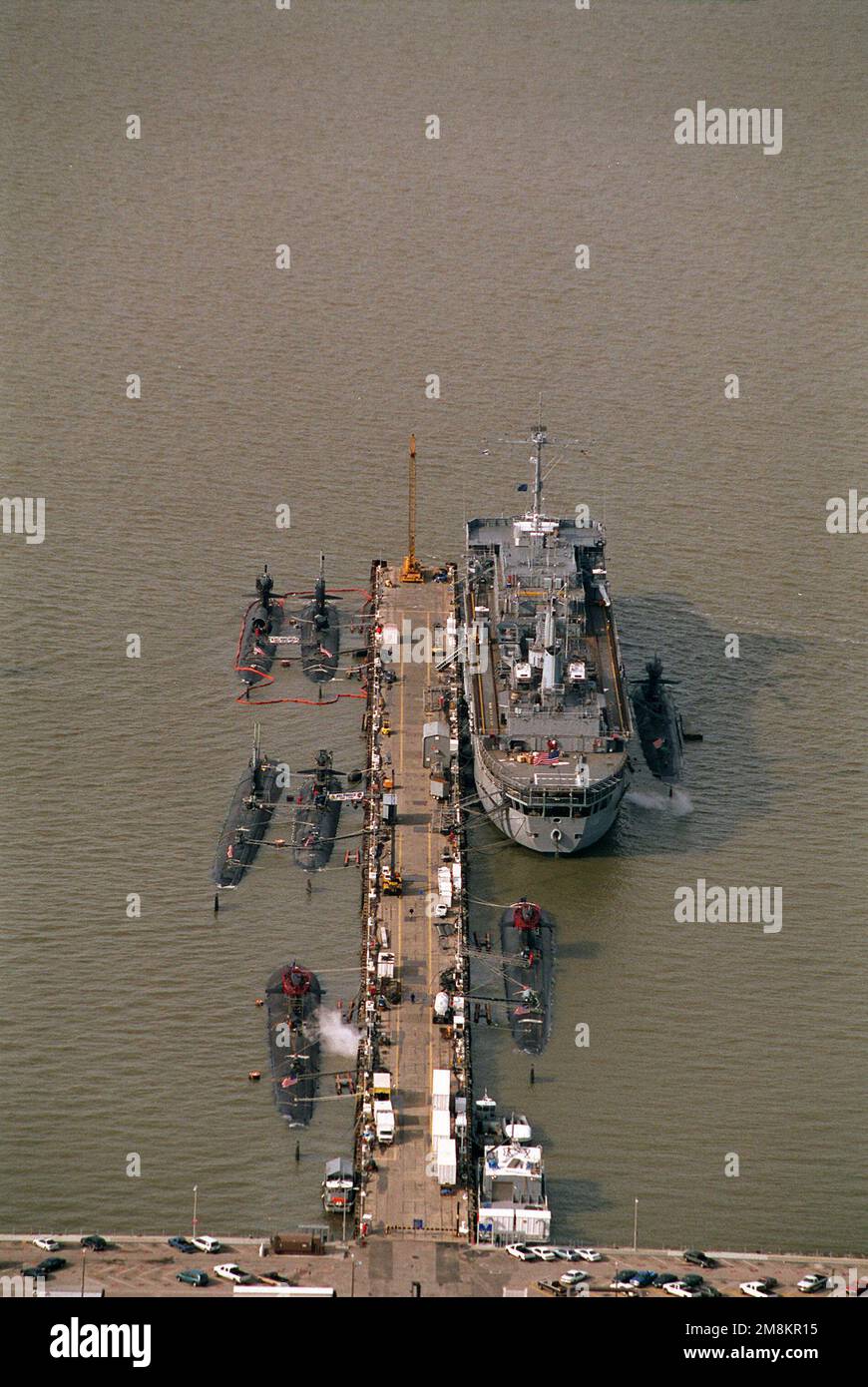A stern view of the submarine tender USS L.Y. Spear (AS-36) tied up at ...