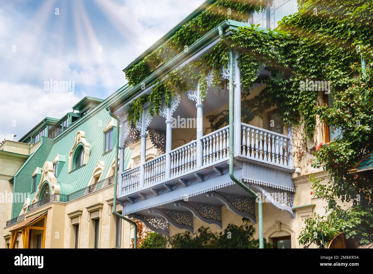 Carved wooden balcony and colorful buildings in historical Tbilisi ...
