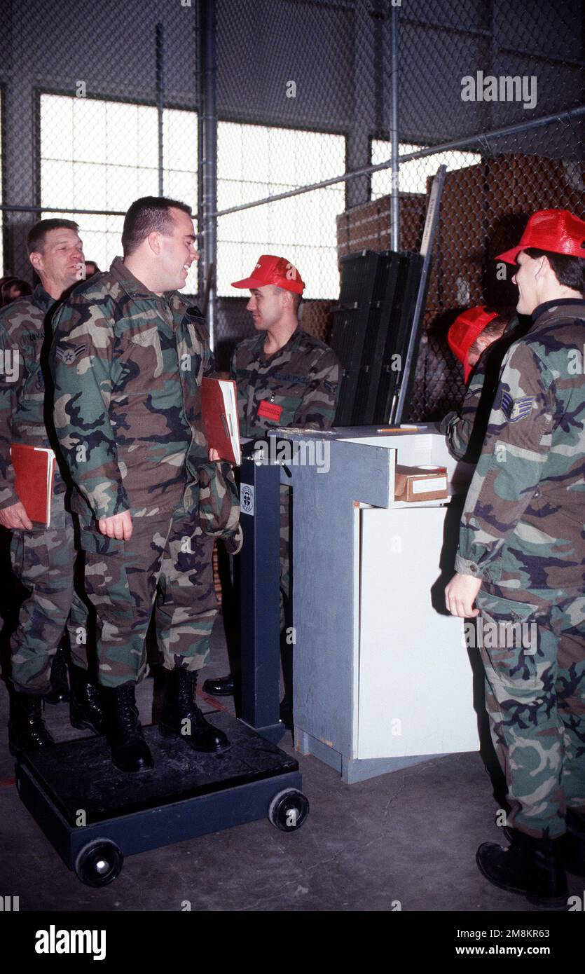 Personnel from the 21st Space Wing are weighed in at the first stop of ...