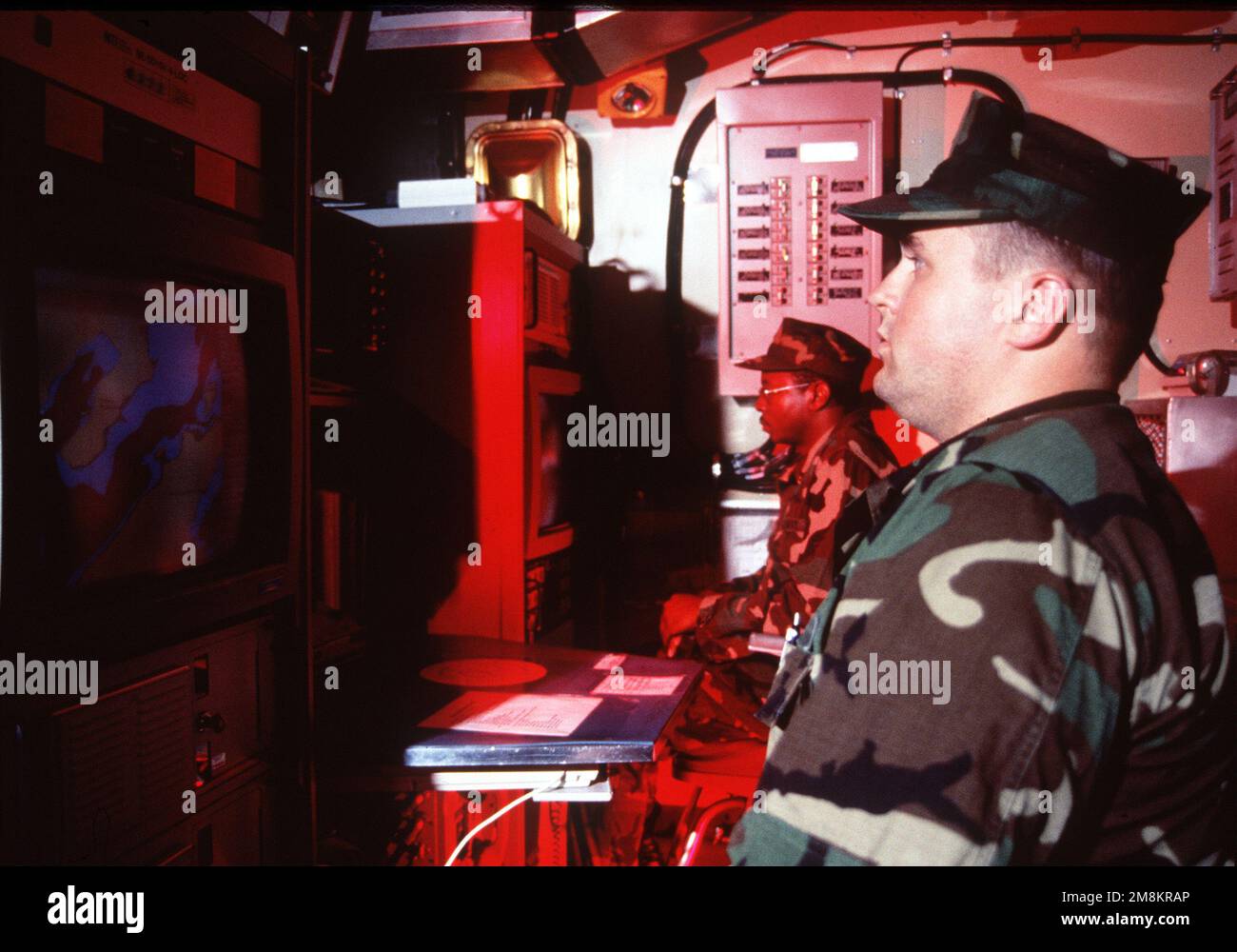 U.S. Navy PETTY Officer Jerome Collins and fellow crew member operates ...