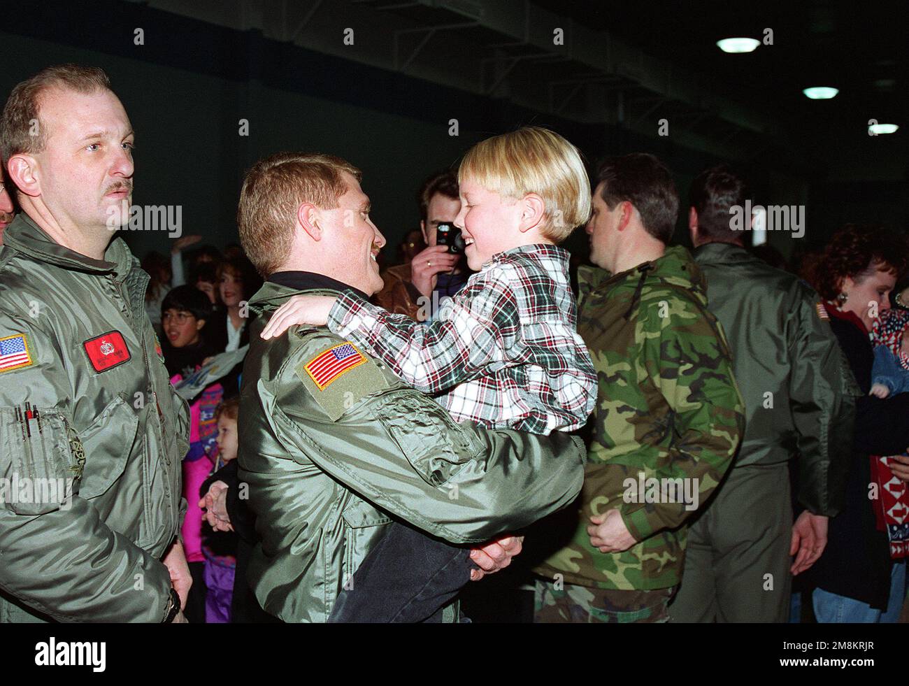 CAPT. Pat Halligan, 50th Airlift Squadron, receives a hug and a smile ...