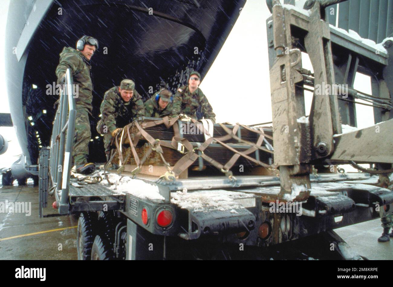 At Tuzla Air Base, Bosnia, members of the 62nd Aerial Port Squadron ...