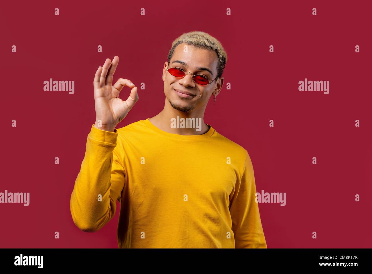 Positive man makes OK hand sign, okay gesture. Happy student guy in ...