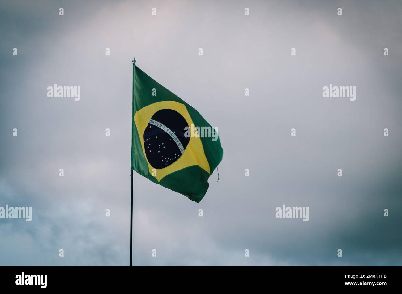Brazil flag waving in a pole with cloudy sky Stock Photo - Alamy