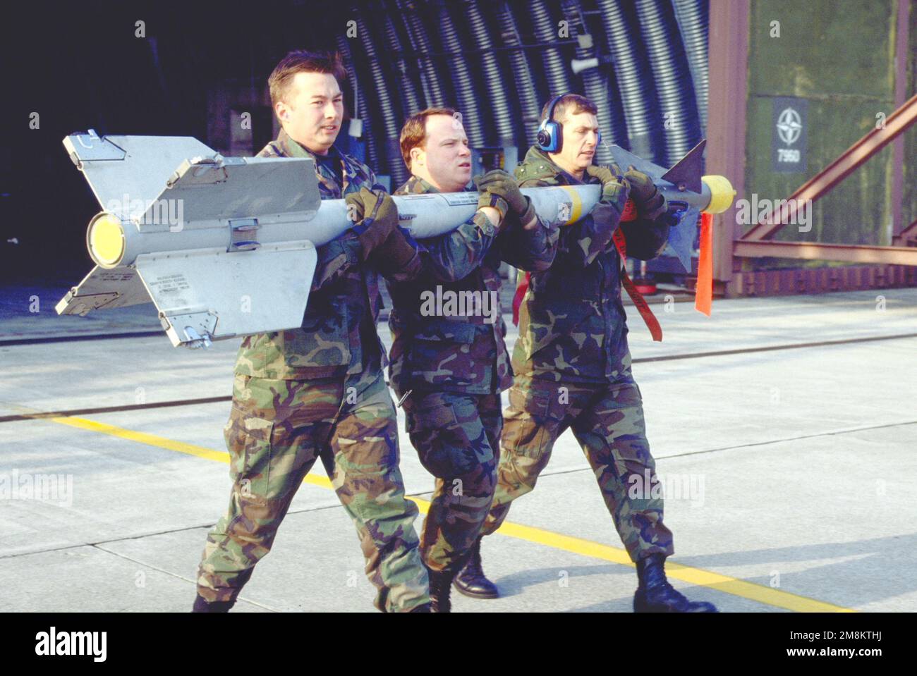 SENIOR AIRMAN Bruce Rogers (left), load crew member; SENIOR AIRMAN ...
