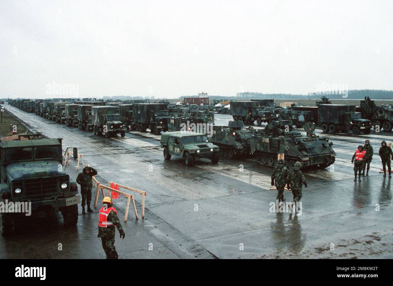 Implementation Force (IFOR) vehicles in a holding area at Taszar Air ...