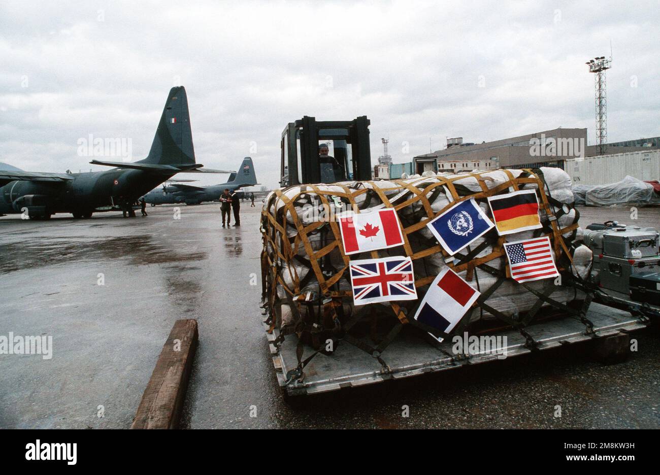 United Nations forces unload a pallet of relief supplies from a ...