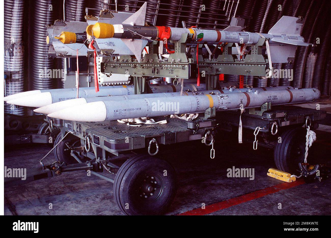A bomb transporter is loaded with AIM-9M Sidewinder missiles and AIM ...