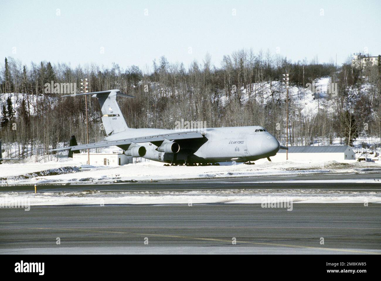 A transient Air Mobility Command (AMC) C-5 Galaxy sits on the ramp in ...