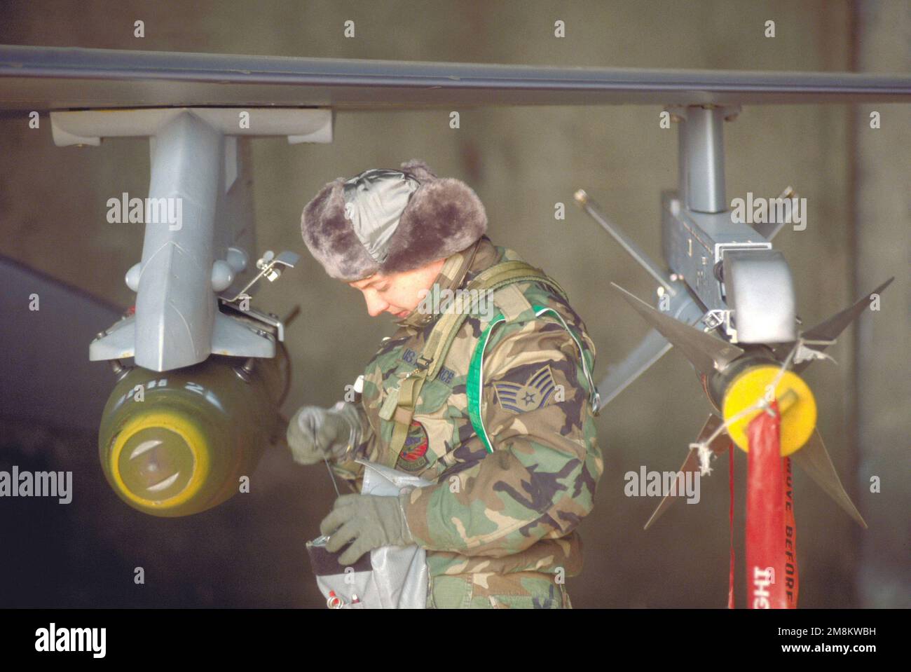 STAFF Sergeant Rick Teshendurf prepares to download weapons from an F ...