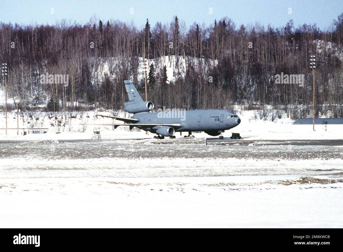 A transient Air Mobility Command (AMC) KC-10 Tanker sits on the snow ...