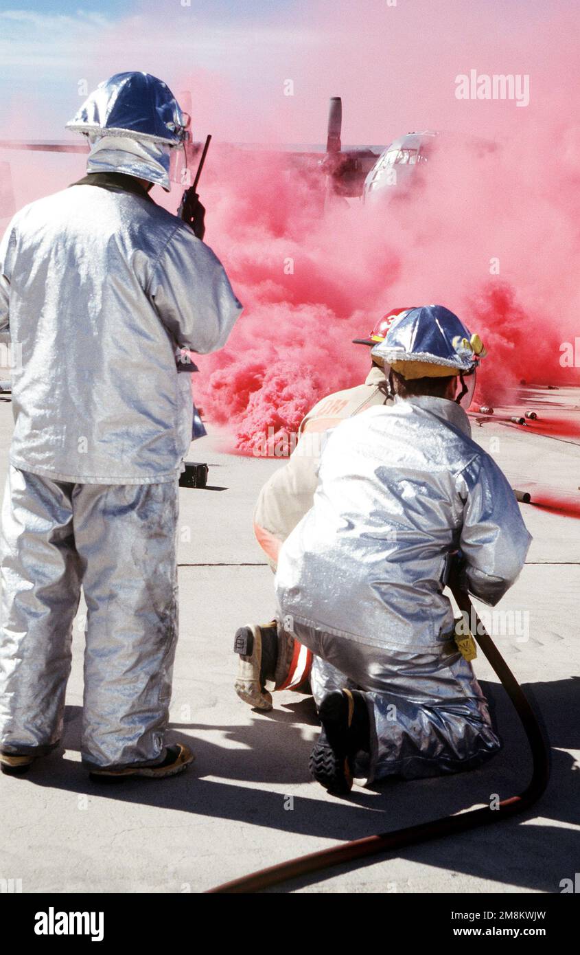 Members of the 355th CES Fire Department simulate putting out an ...