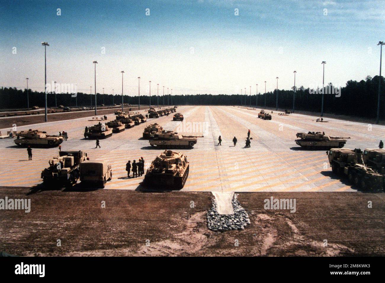 M-1 Abrams Tanks and other vehicles move across the rail marshaling ...