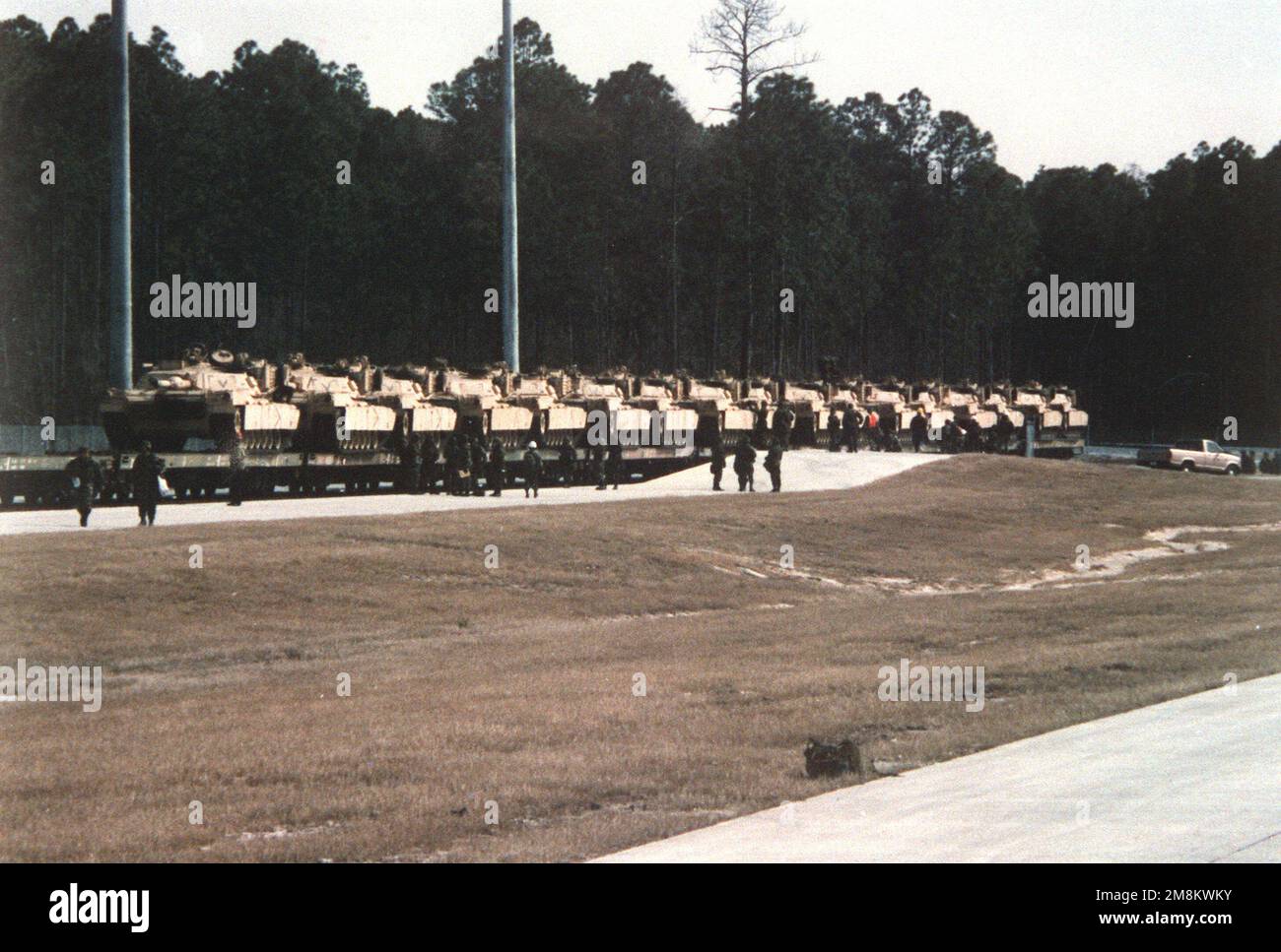 M-1 Abrams Tanks are lined up on flatbed railcars at the rail ...