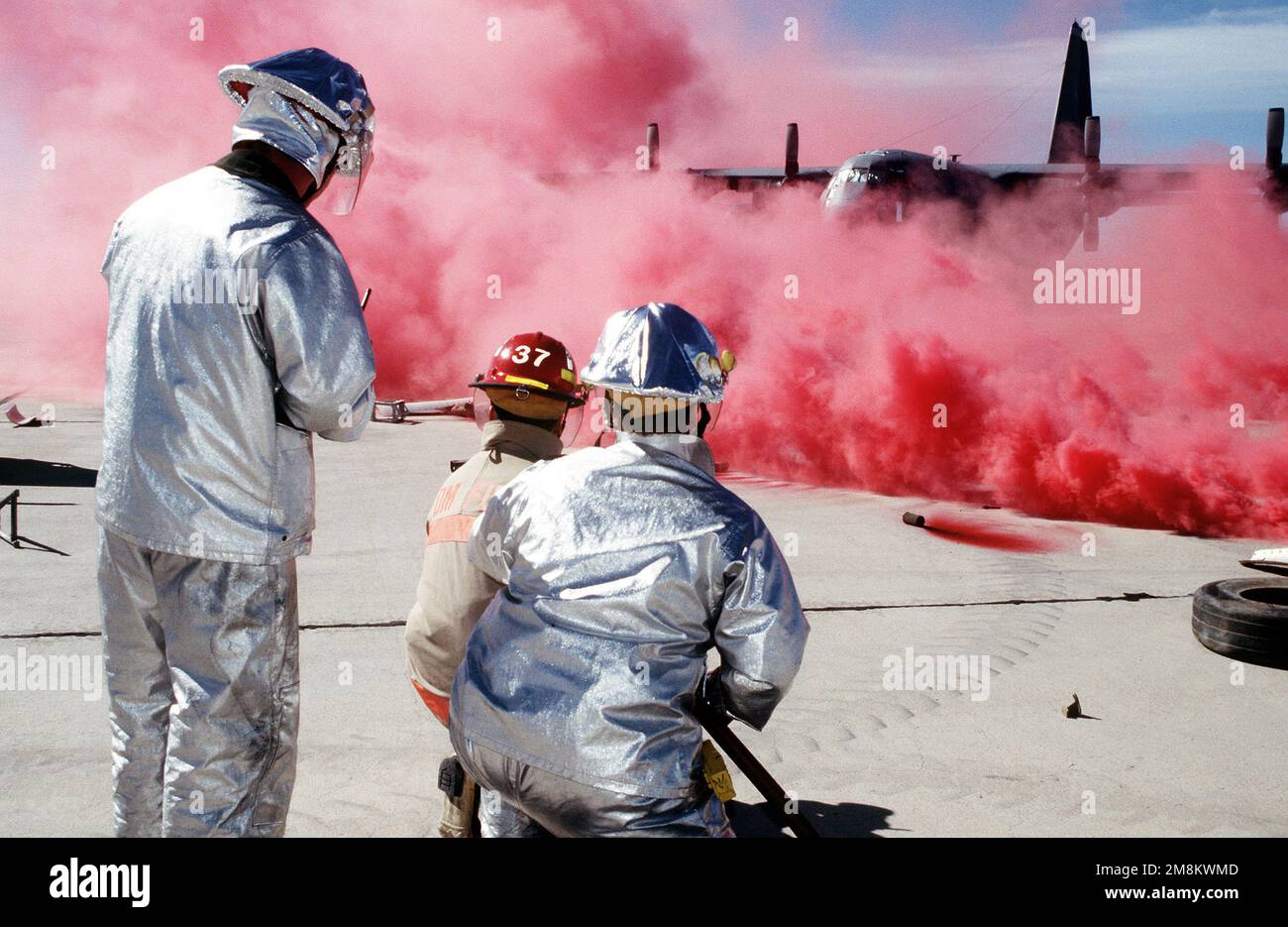 Members of the 355th CES Fire Department simulate putting out an ...
