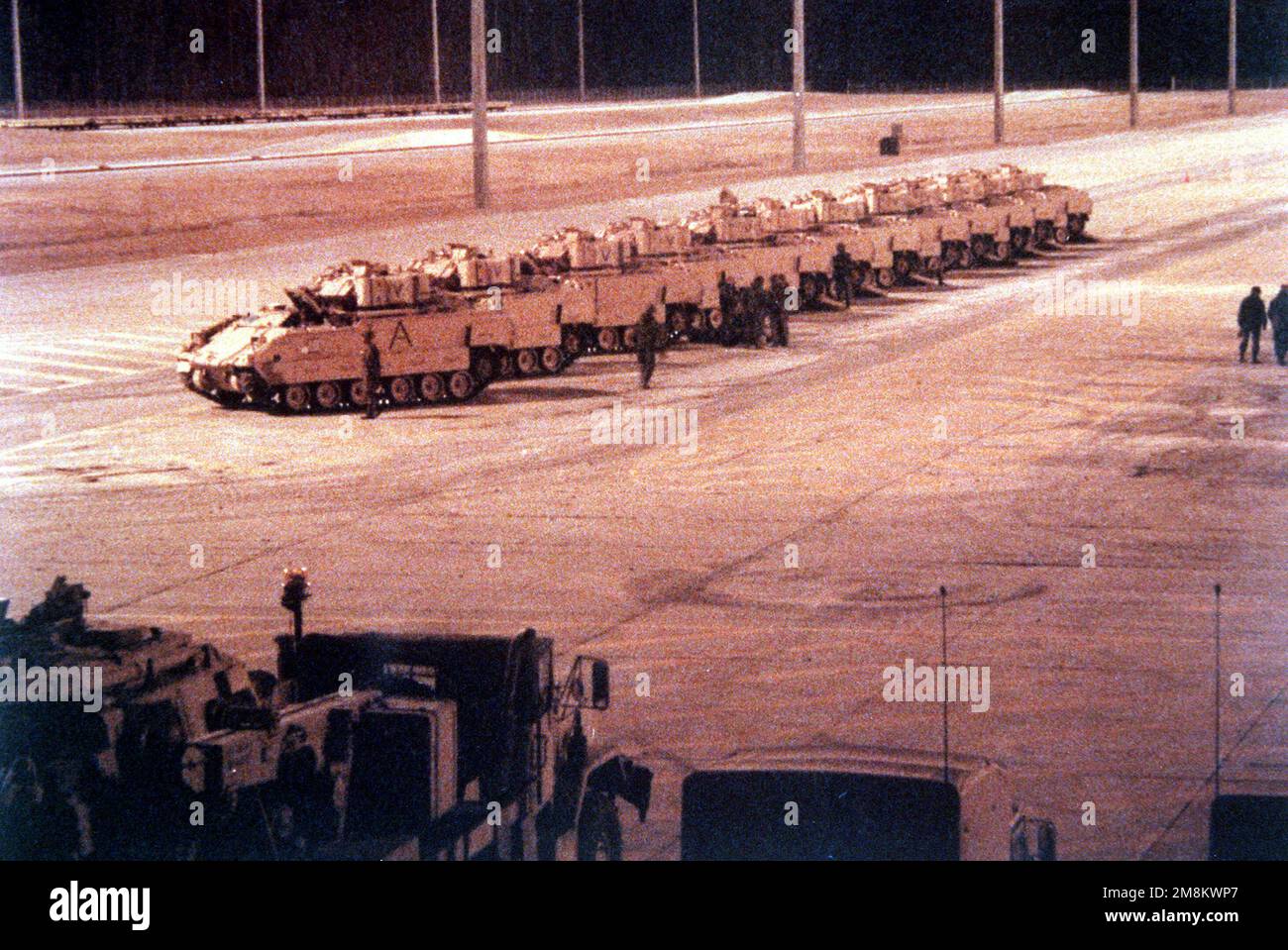 M-2 Bradleys are lined up at the well lighted rail marshaling area ...