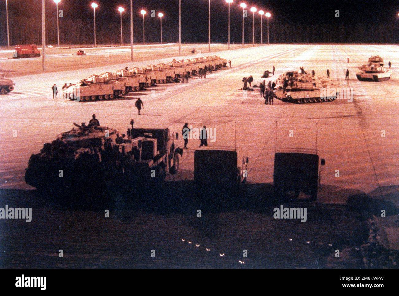M-1 Abrams Tanks are positioned behind M-2 Bradleys at the well lighted ...