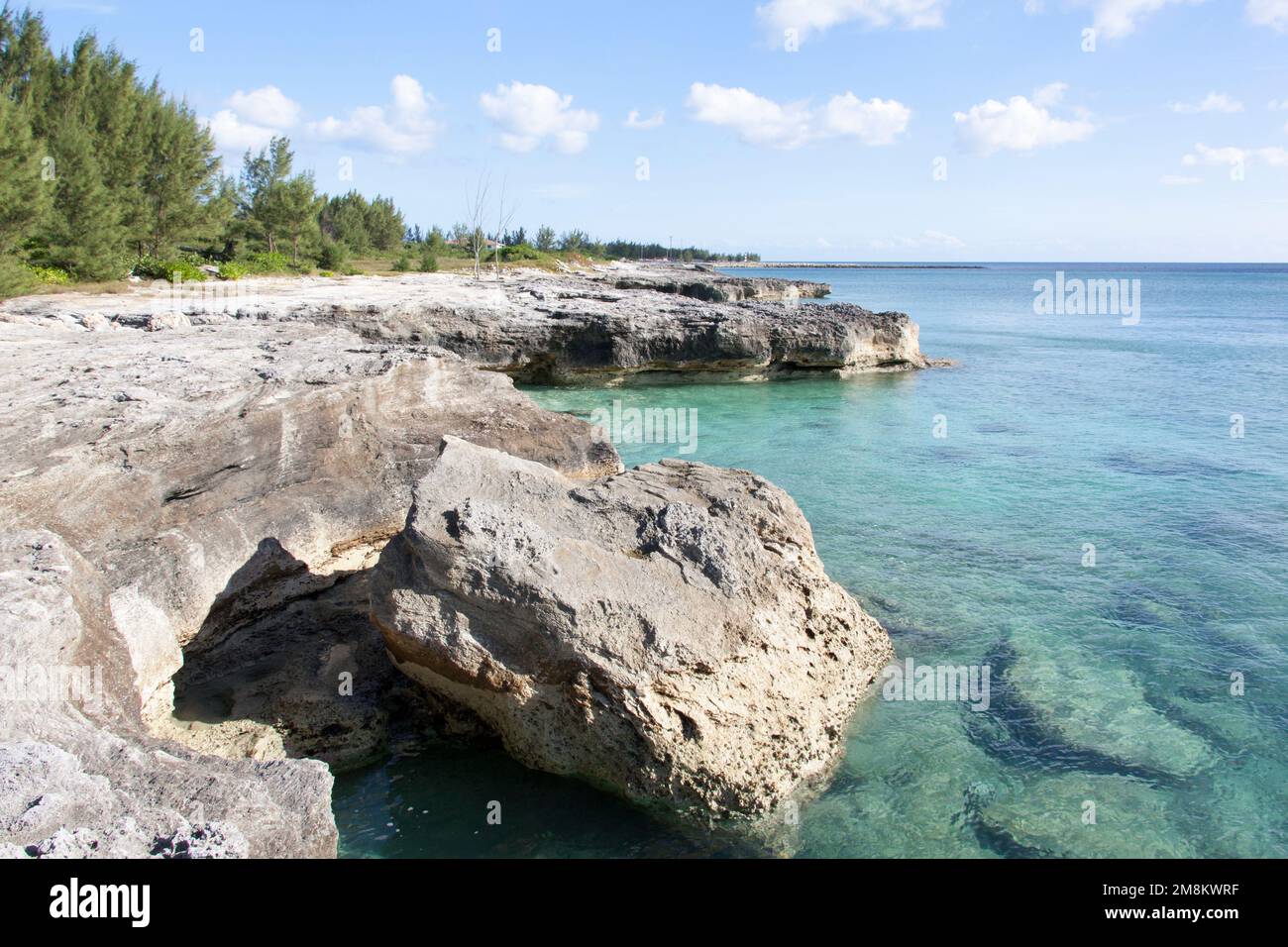 The view of a big rock fallen apart and a steep rocky coastline on ...