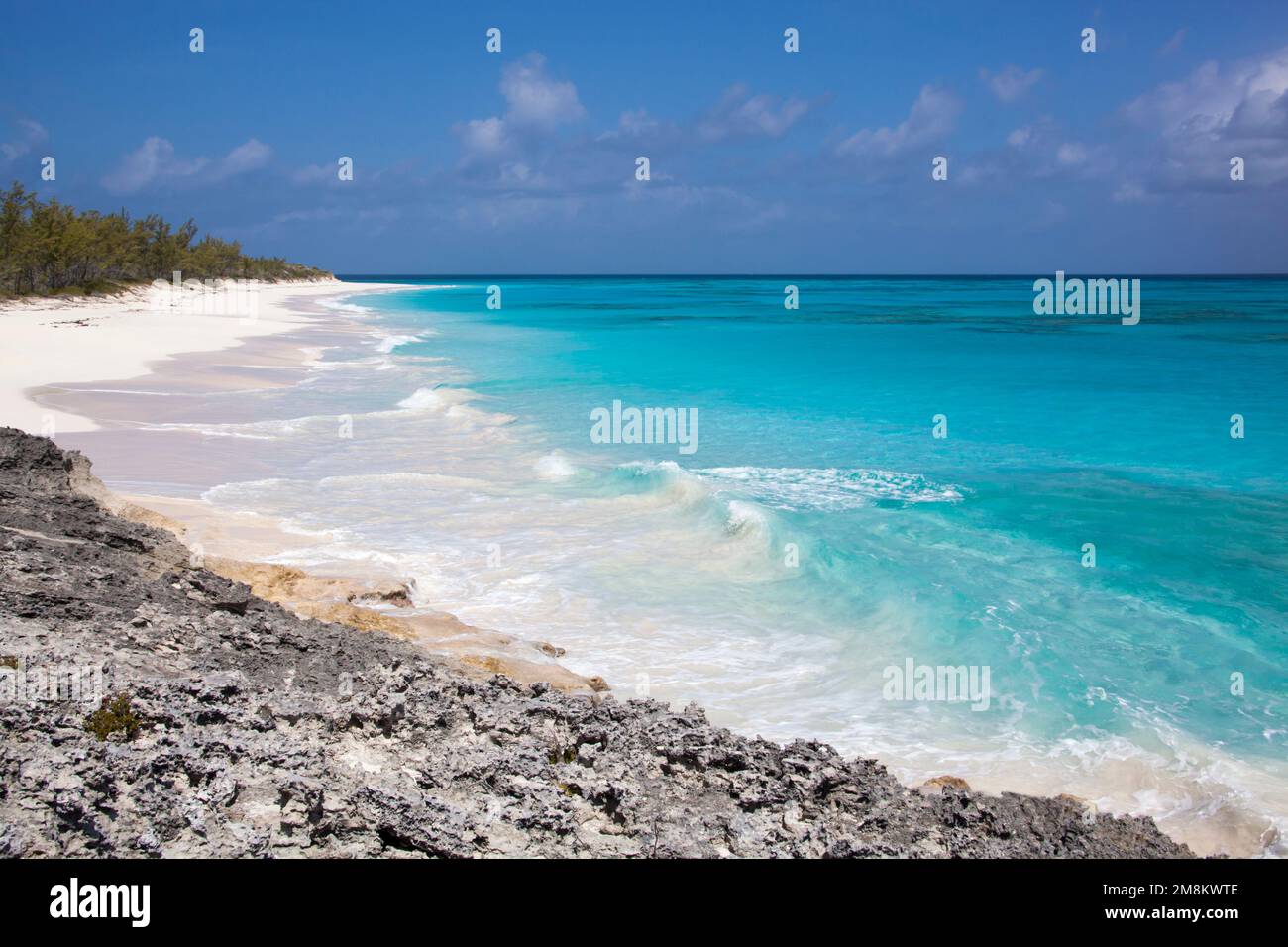 The scenic view of turquoise color waves watching empty sandy beach on ...