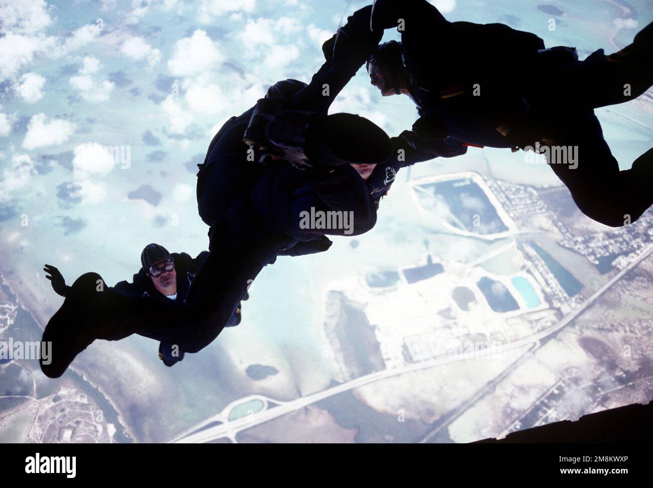 Members of the U.S. Navy's parachute team, the Leap Frogs, exit the ...