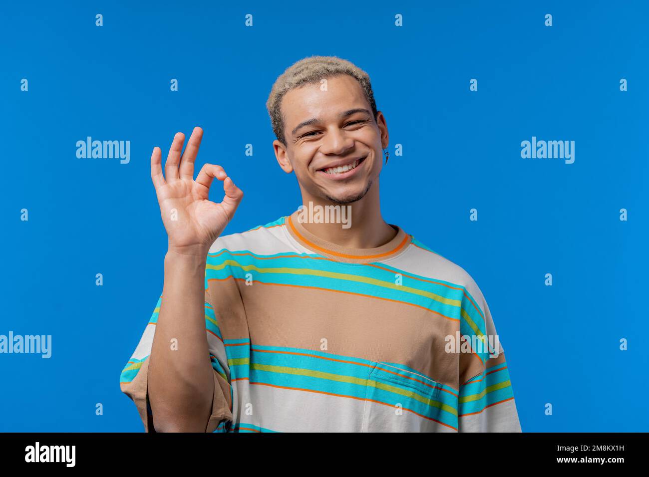 Positive man makes OK hand sign, okay gesture. Happy student guy ...