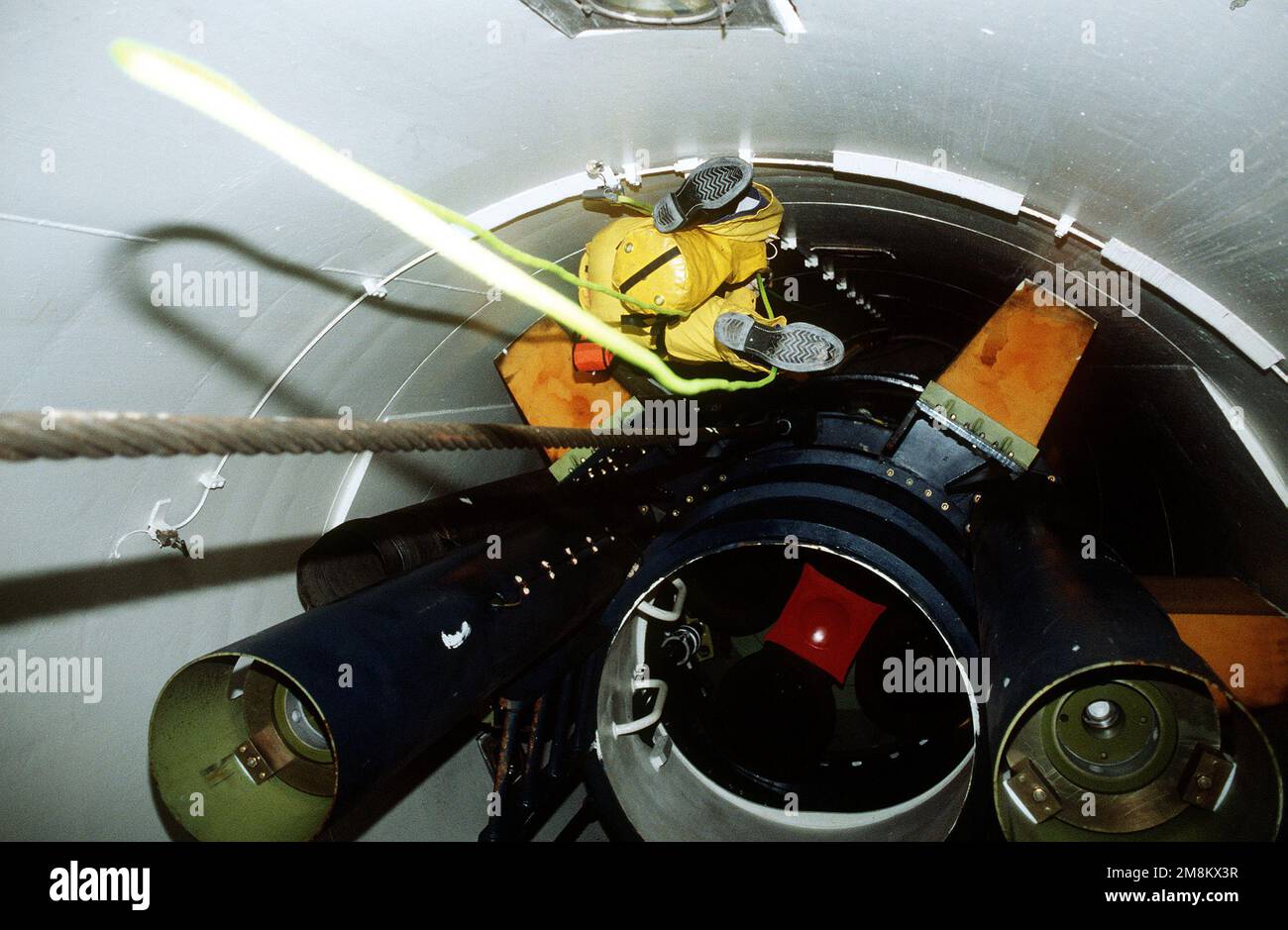 Brian Kelly, a fireman with the 90th CES, hangs head first down a ...